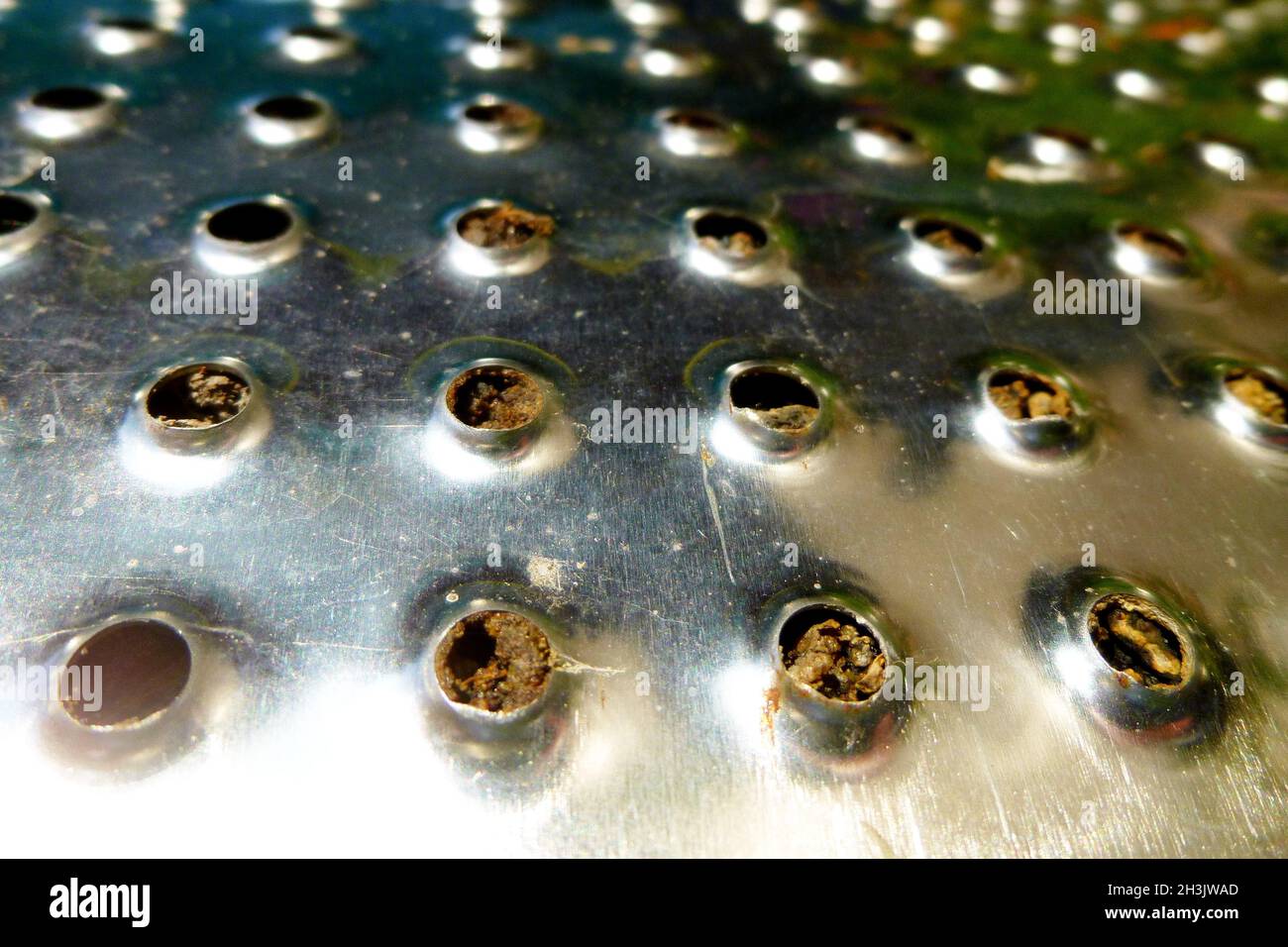 Shiny metal curved surface with holes. Background image Stock Photo - Alamy