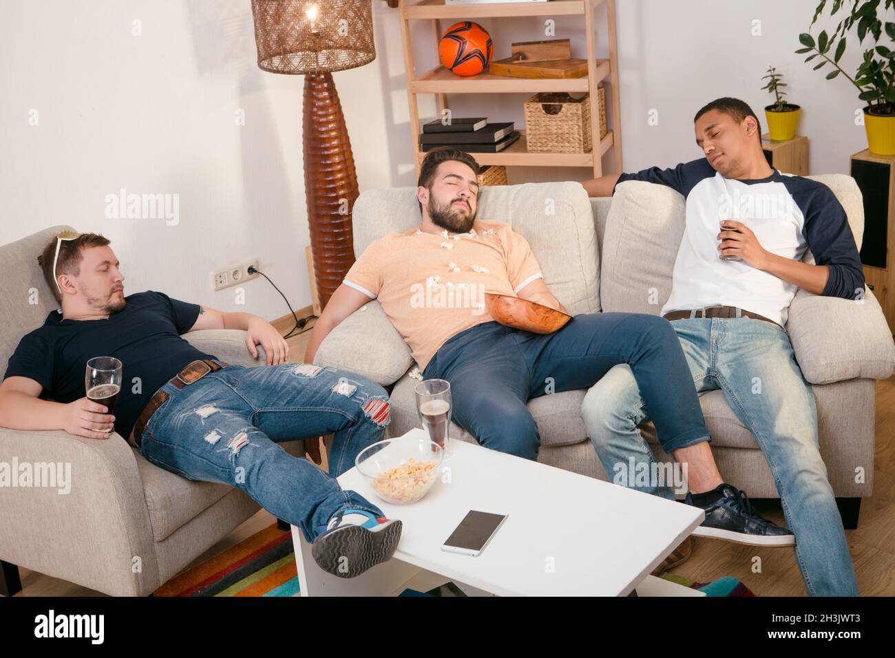 Happy friends resting after football party Stock Photo - Alamy