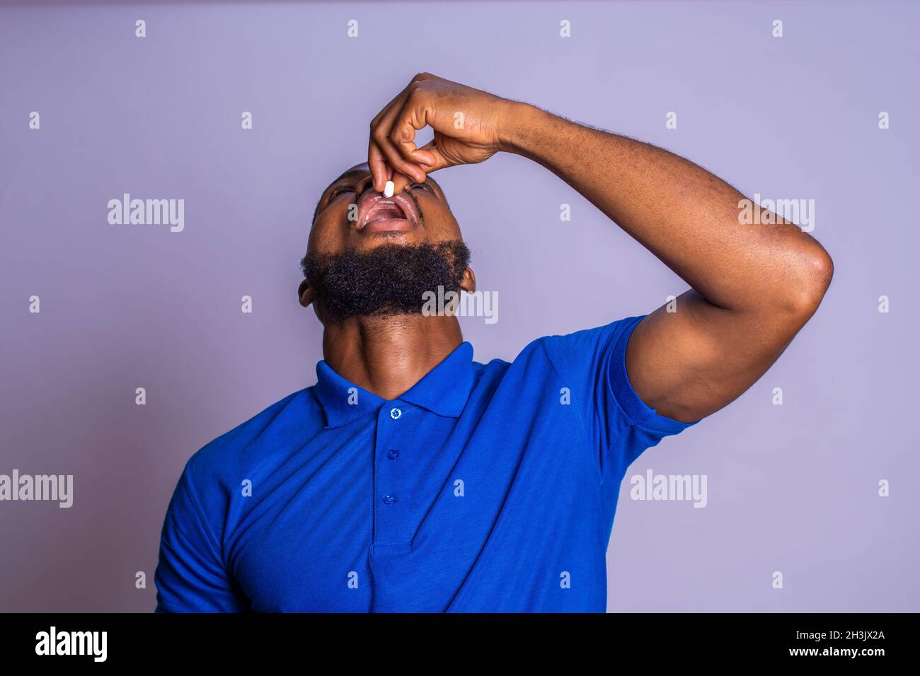 young black man taking his medication Stock Photo - Alamy