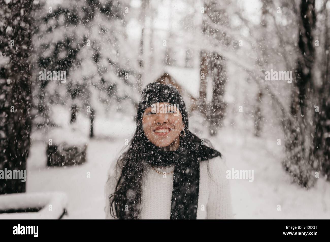 Cute smiling Hispanic woman wearing warm winter clothes posing in a ...