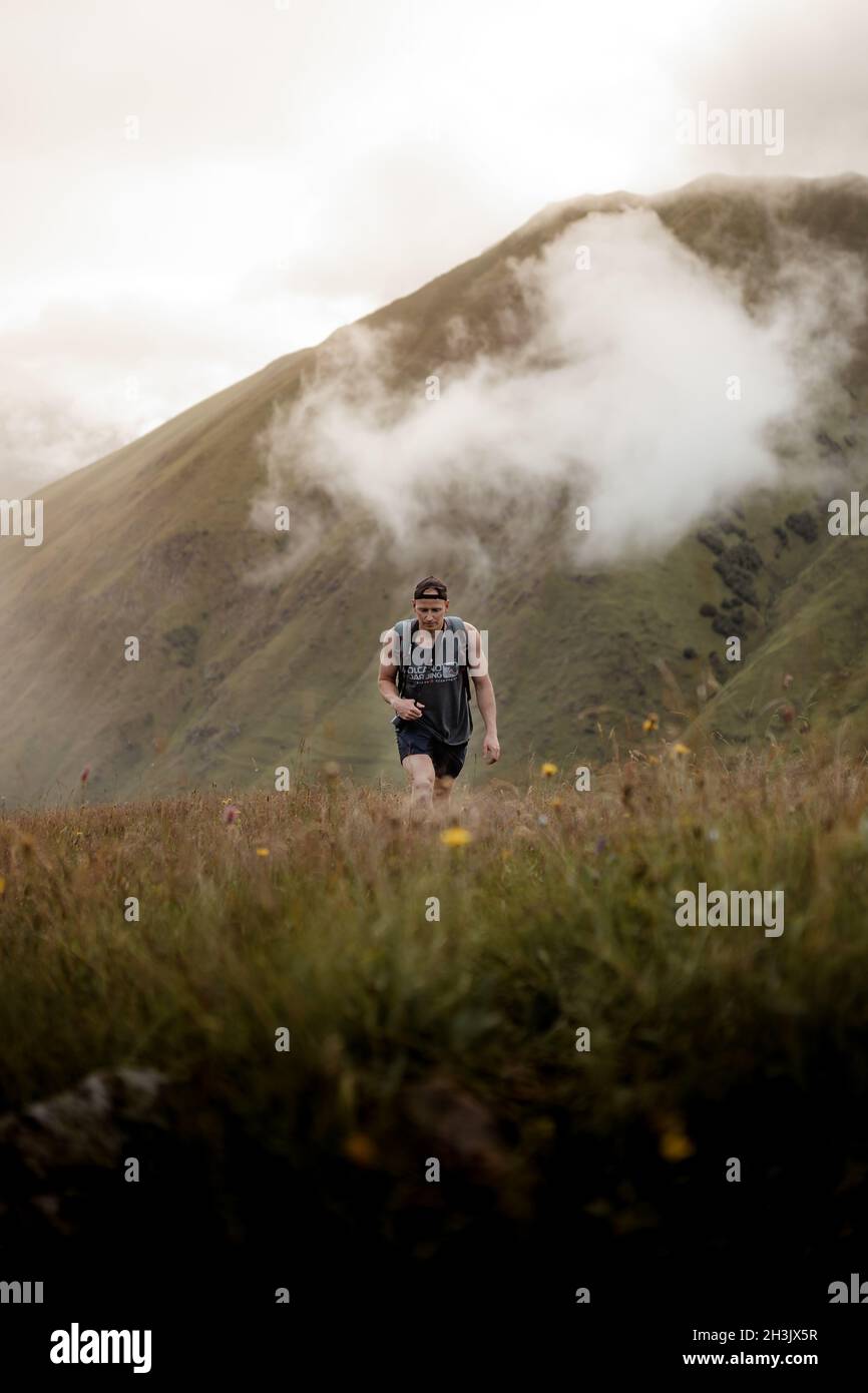 Walking up grassy slope hi-res stock photography and images - Alamy