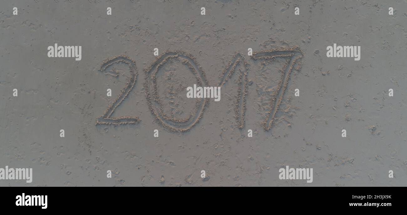 Year 2017 written on sand of tropical beach Stock Photo - Alamy