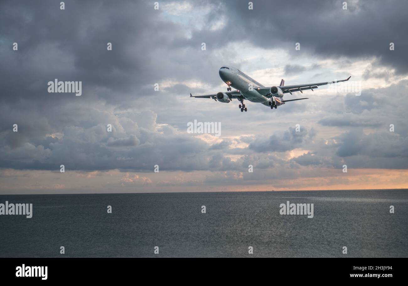 Wing of aeroplane over ocean island hi-res stock photography and images ...