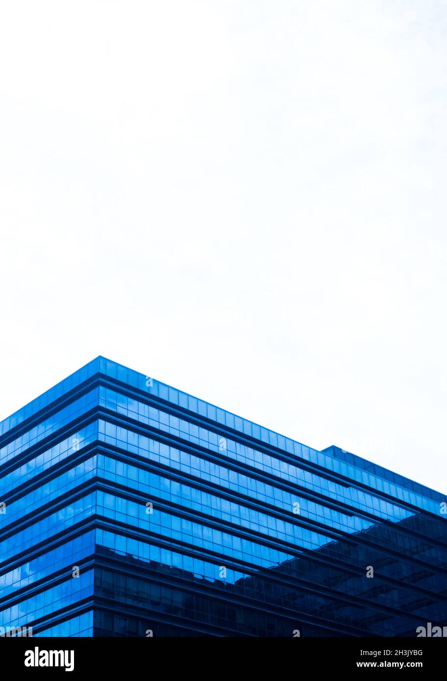 Mirrored building against cloudy sky background Stock Photo - Alamy