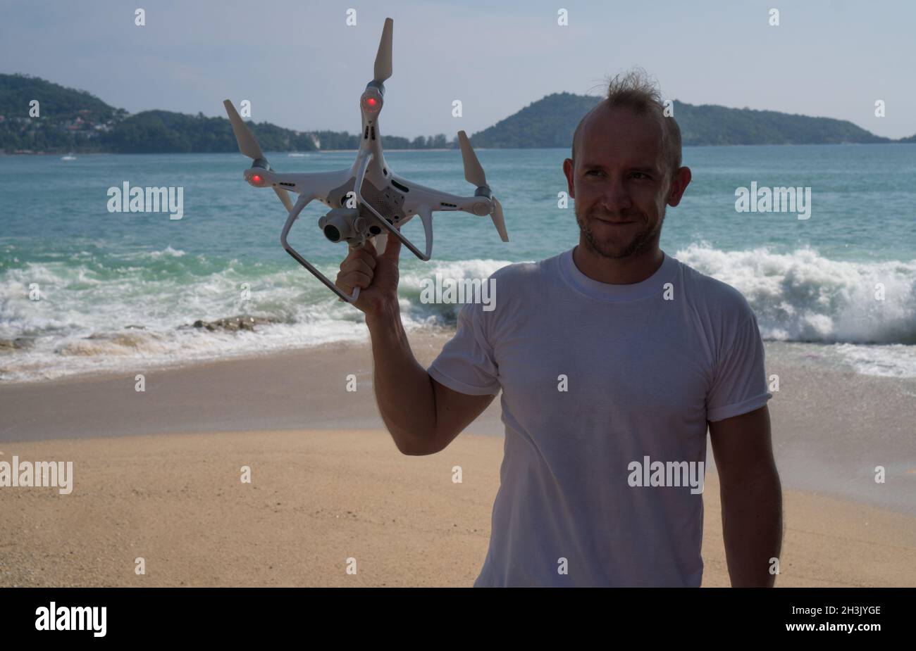 Happy man with drone camera in his hand on the beach Stock Photo - Alamy