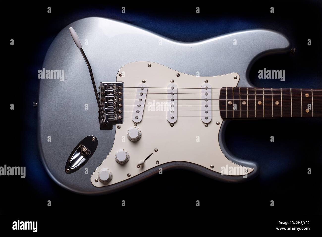 Silver electric guitar isolated on black background Stock Photo - Alamy