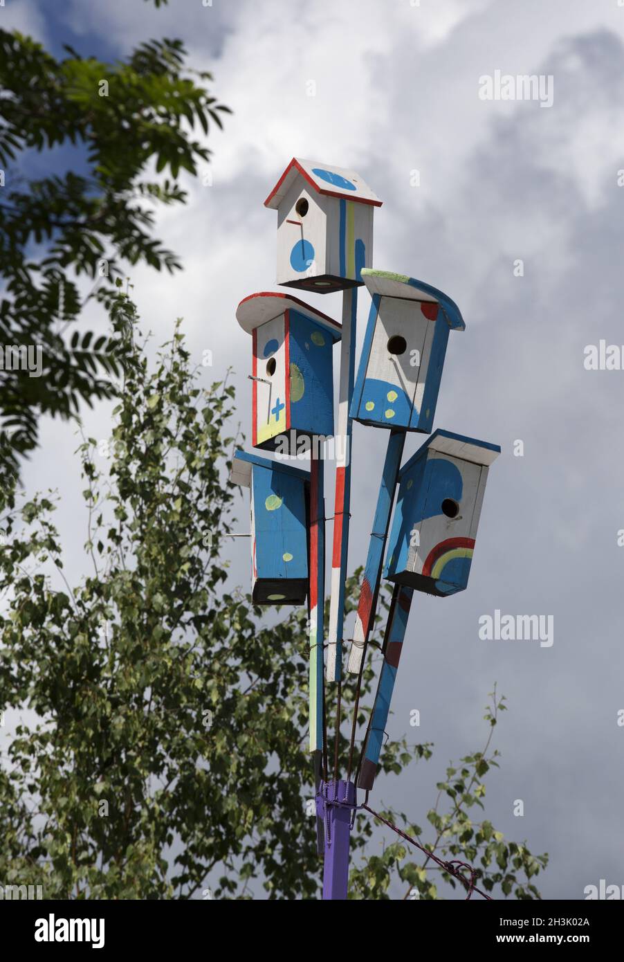 Lots of colorful nesting boxes on a pole Stock Photo - Alamy