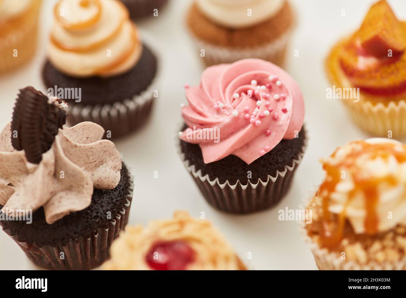 Different colorful small cupcakes with decoration for birthday party ...