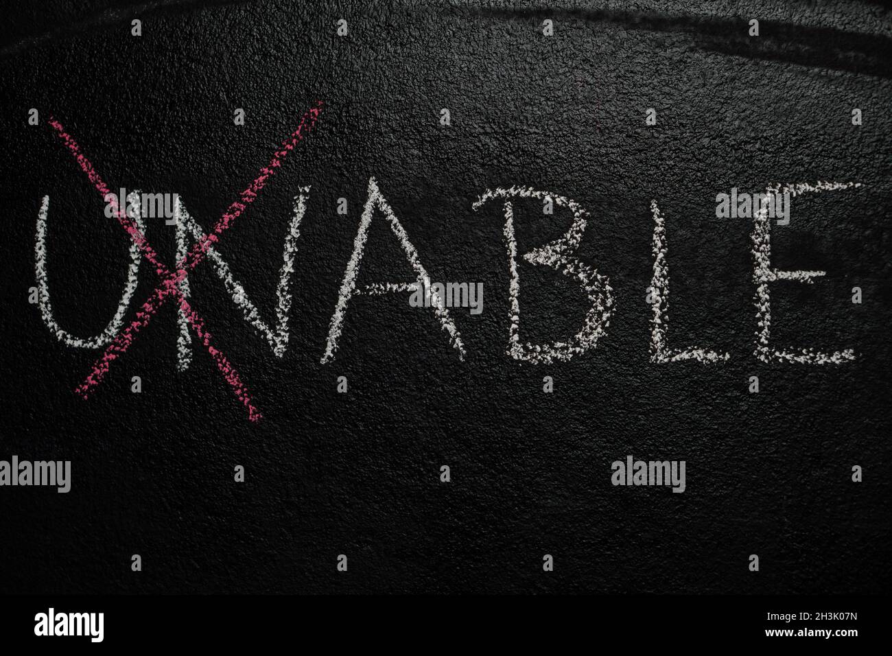 Cross over unable word on black chalkboard Stock Photo - Alamy