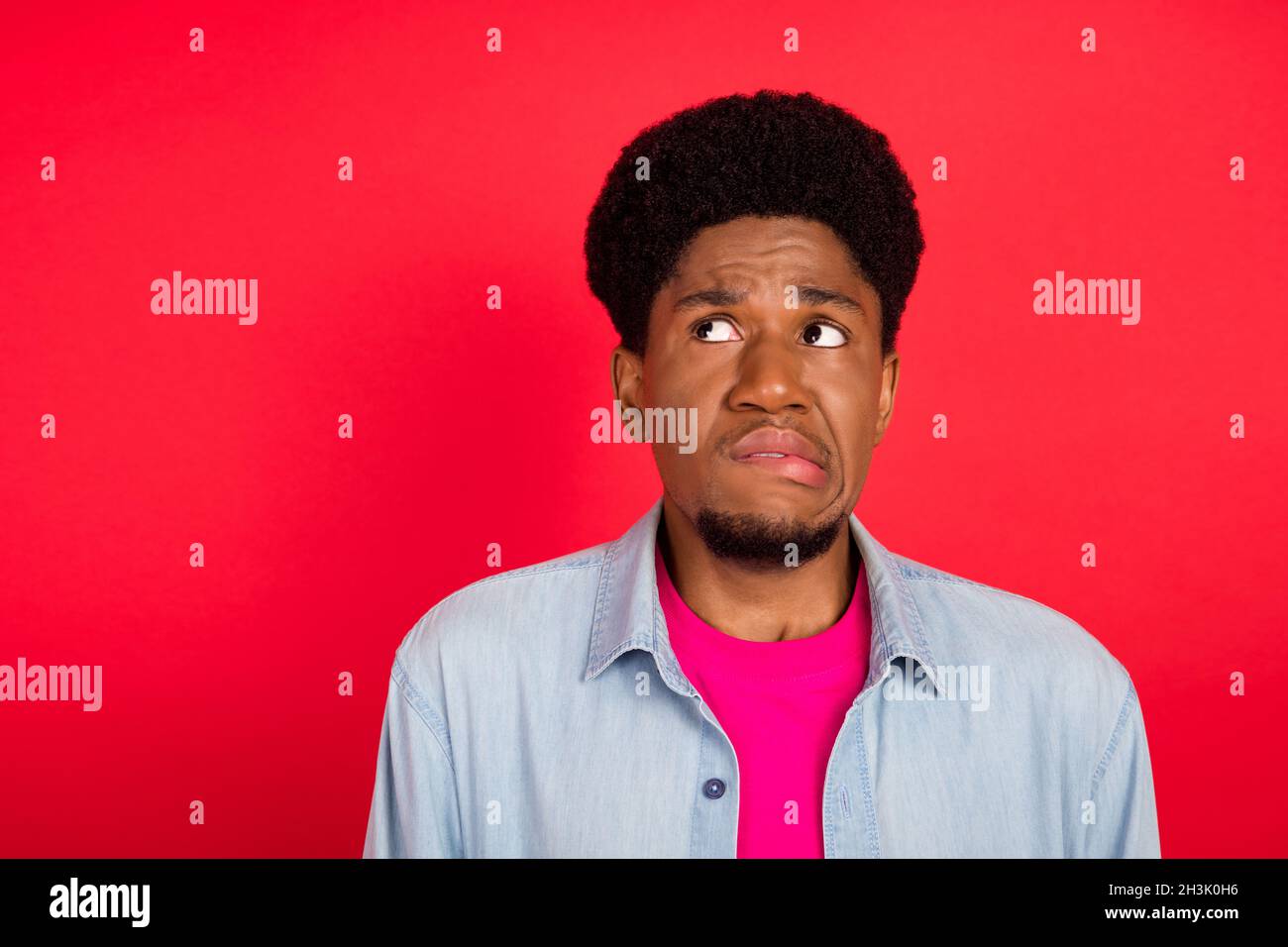 Portrait of attractive scared afraid brunet guy worrying biting lip ...