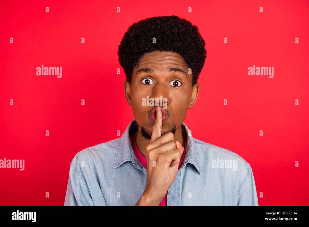 Portrait of attractive mysterious brunet guy showing shh sign keep ...