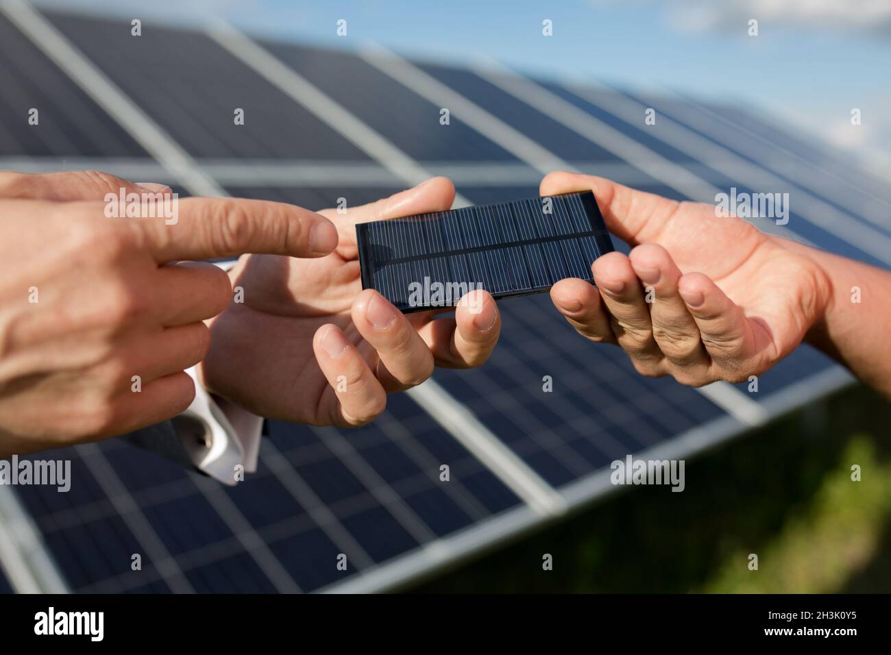Solar energy, two hands holding photovoltaic item Stock Photo - Alamy
