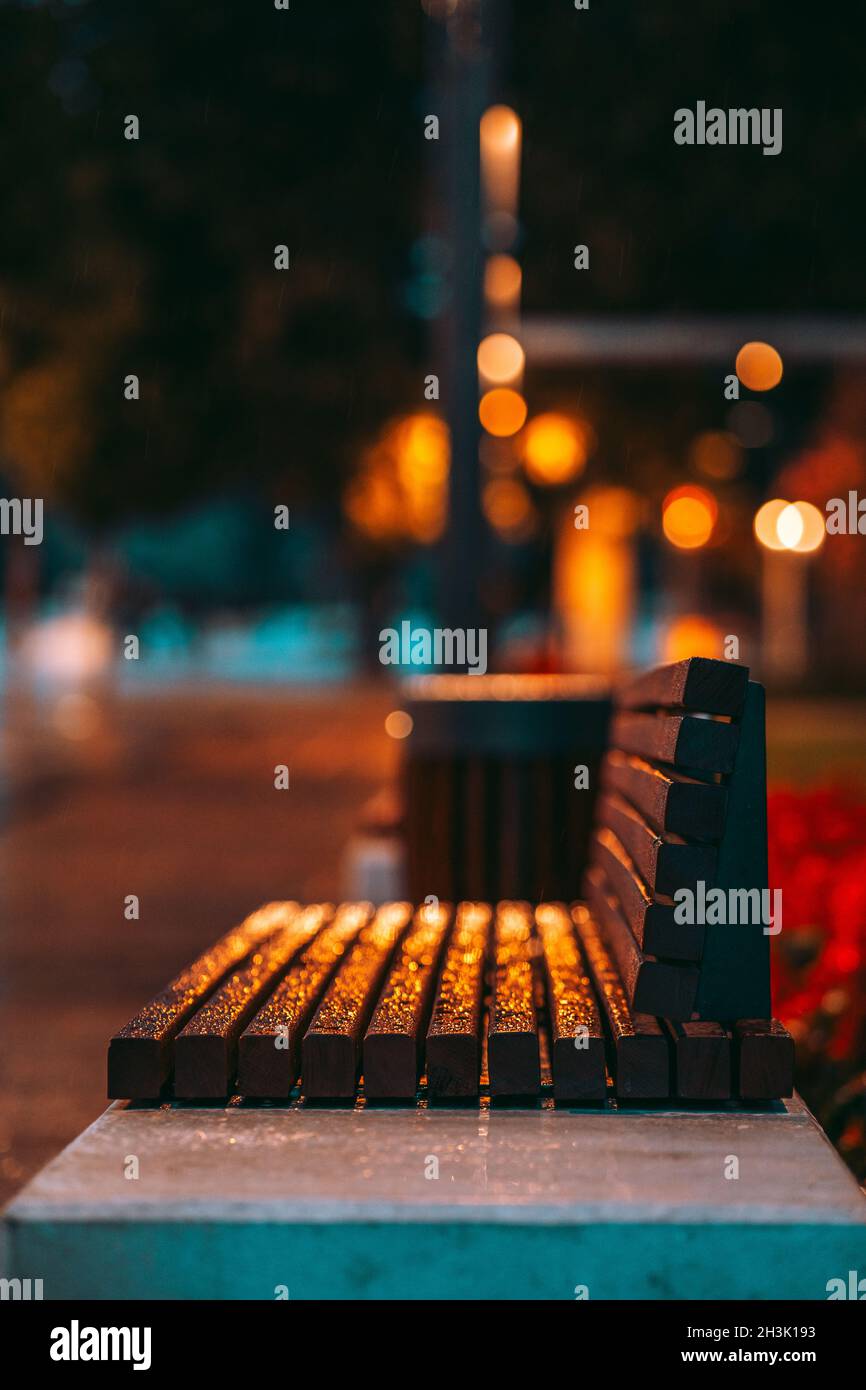 Park bench on a rainy night autumn night Stock Photo - Alamy