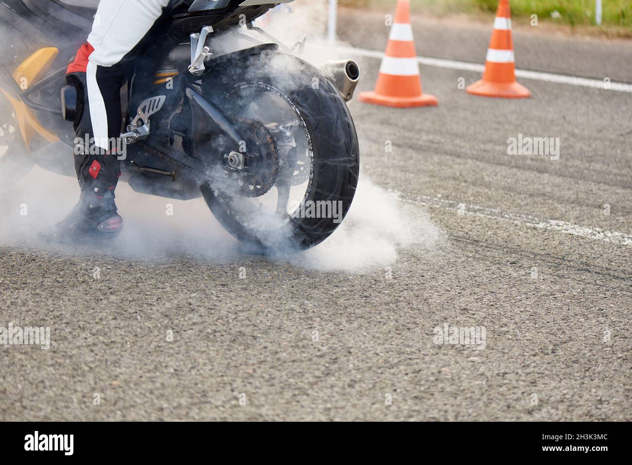 A motorcycle wheel in smoke on a race track Stock Photo - Alamy