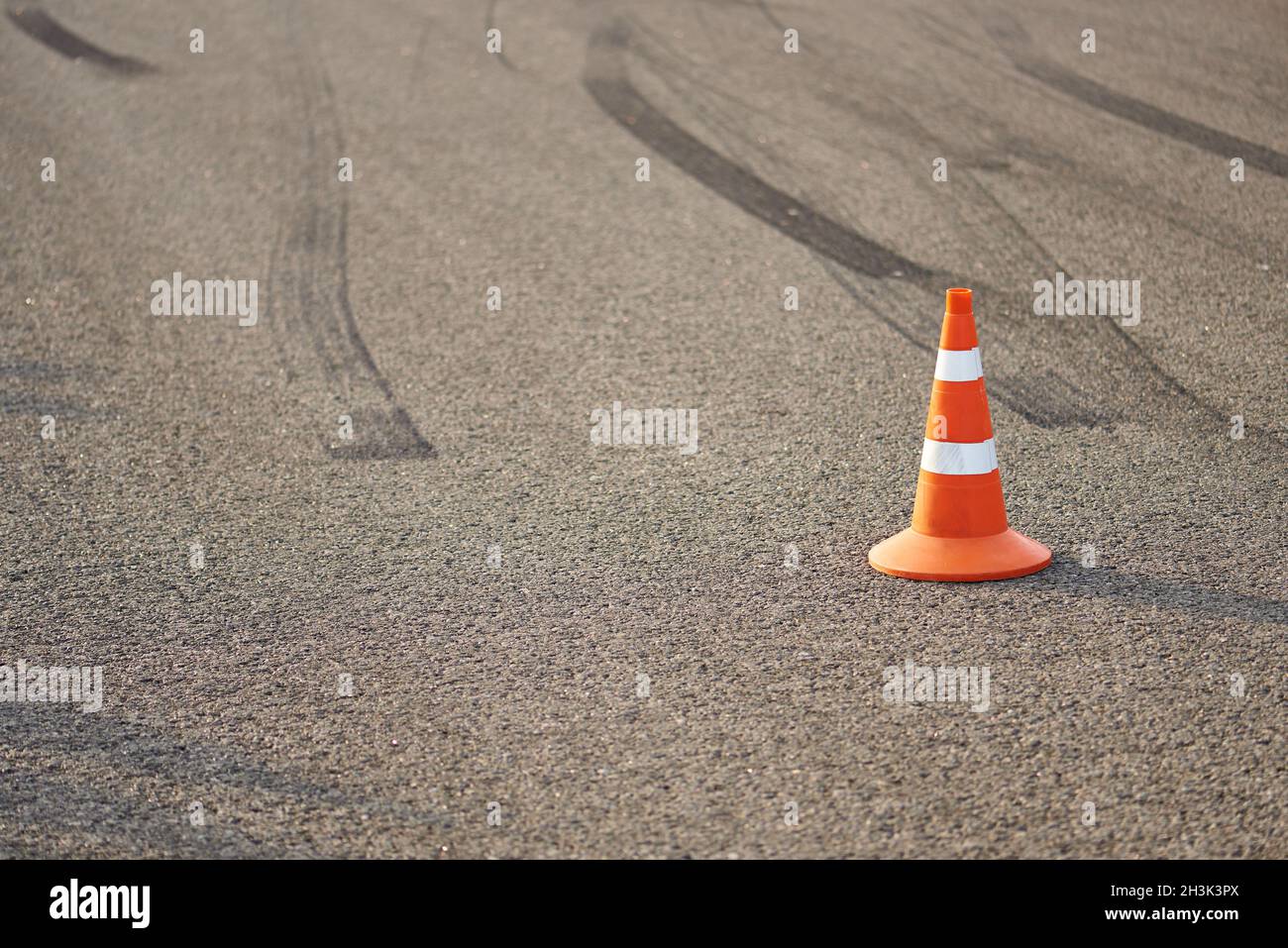 Orange traffic cone on a race track with copy space Stock Photo - Alamy