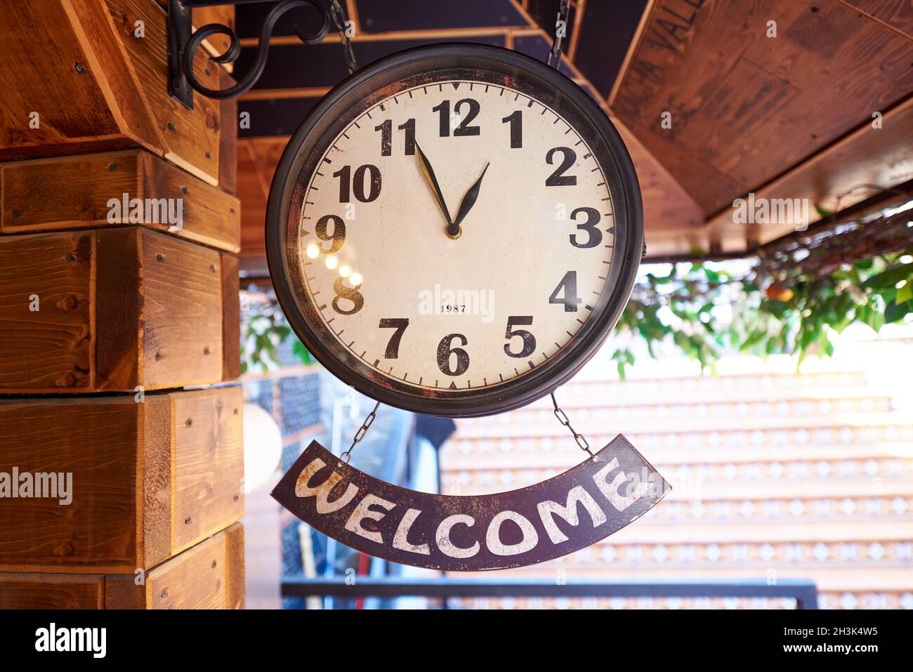Vintage clock with welcome sign Stock Photo - Alamy