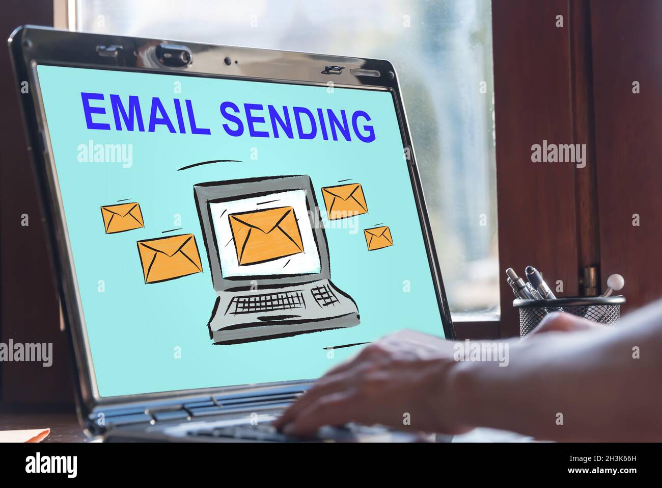 Laptop screen displaying an email sending concept Stock Photo - Alamy