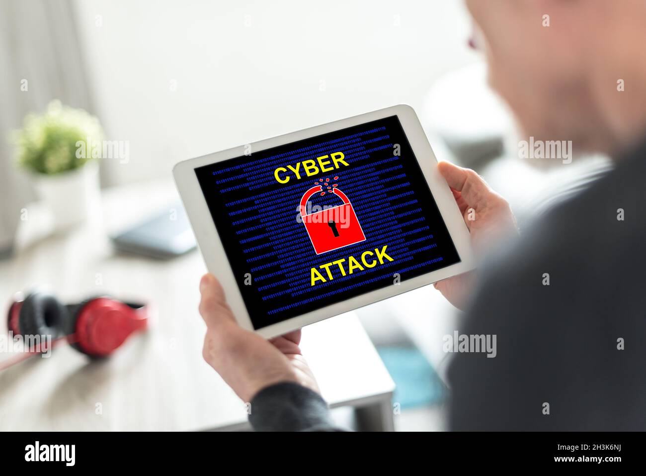 Tablet screen displaying a cyber attack concept Stock Photo - Alamy
