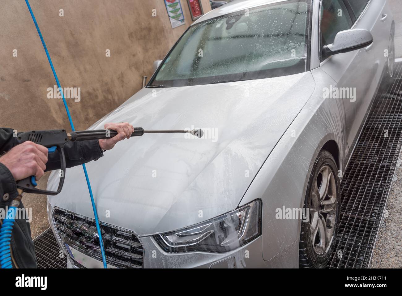 Car washing with a high pressure water jet Stock Photo - Alamy