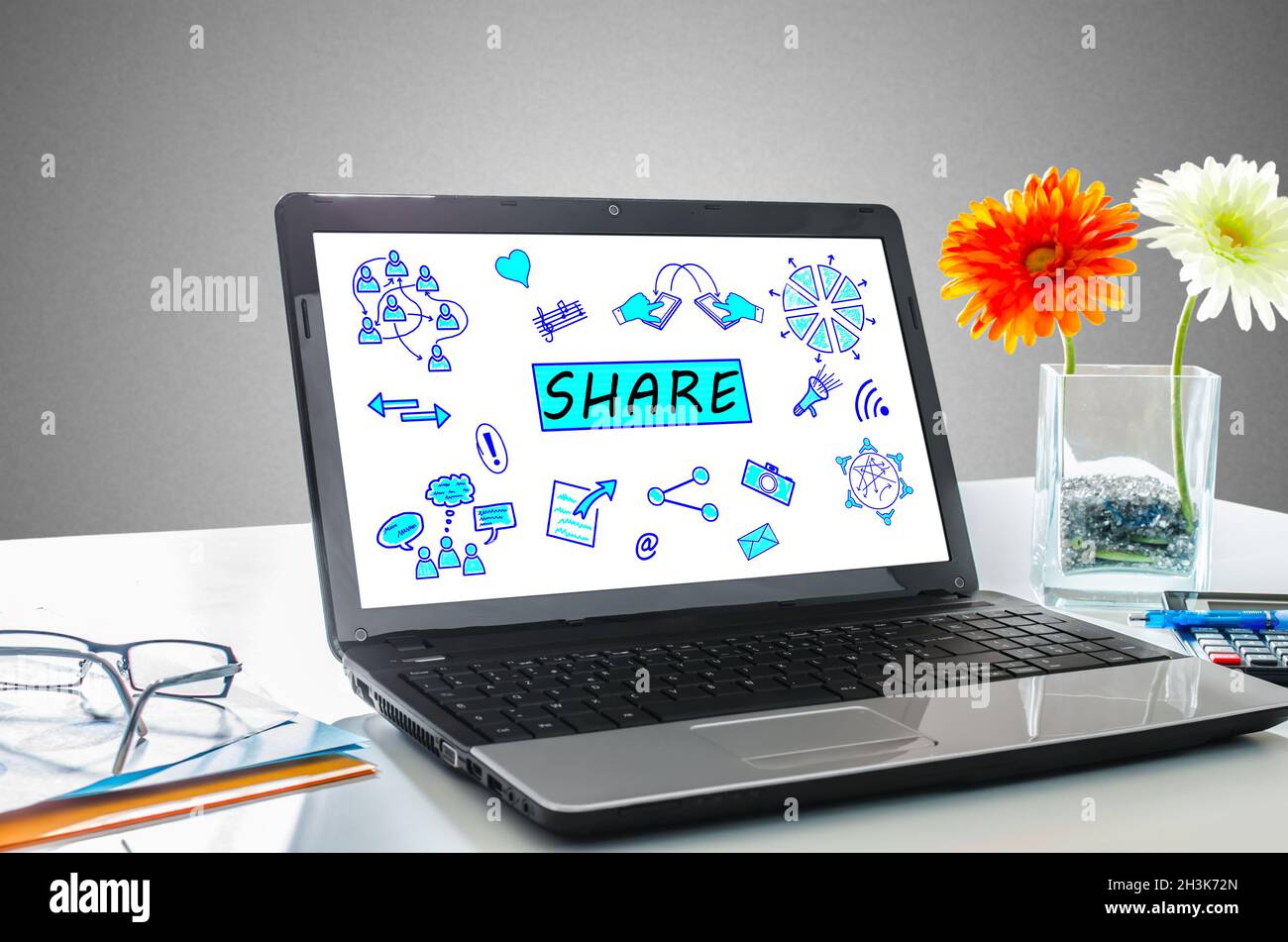 Laptop screen showing share concept Stock Photo - Alamy