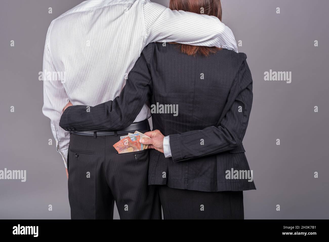 Woman stealing money in the back pocket of her lover Stock Photo - Alamy