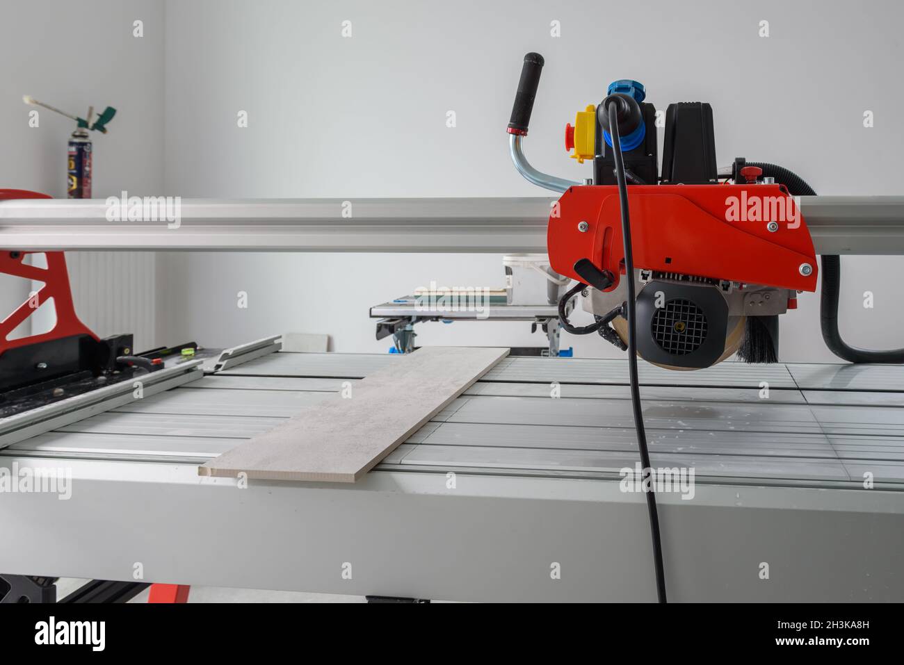Cutter machine for ceramic tiles. A flat during renovation Stock Photo ...