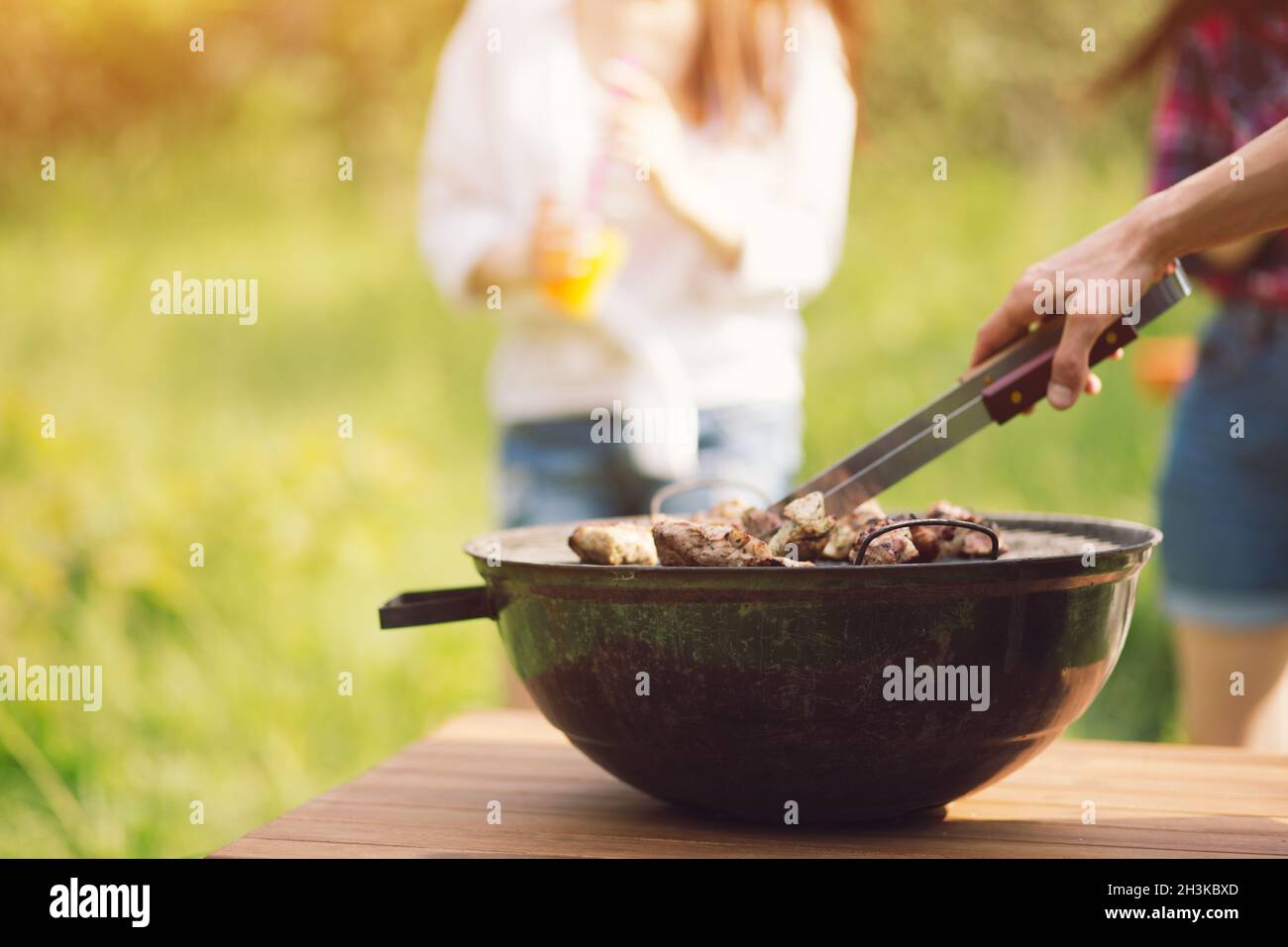 Grill standing on picnic table outdoors Stock Photo - Alamy