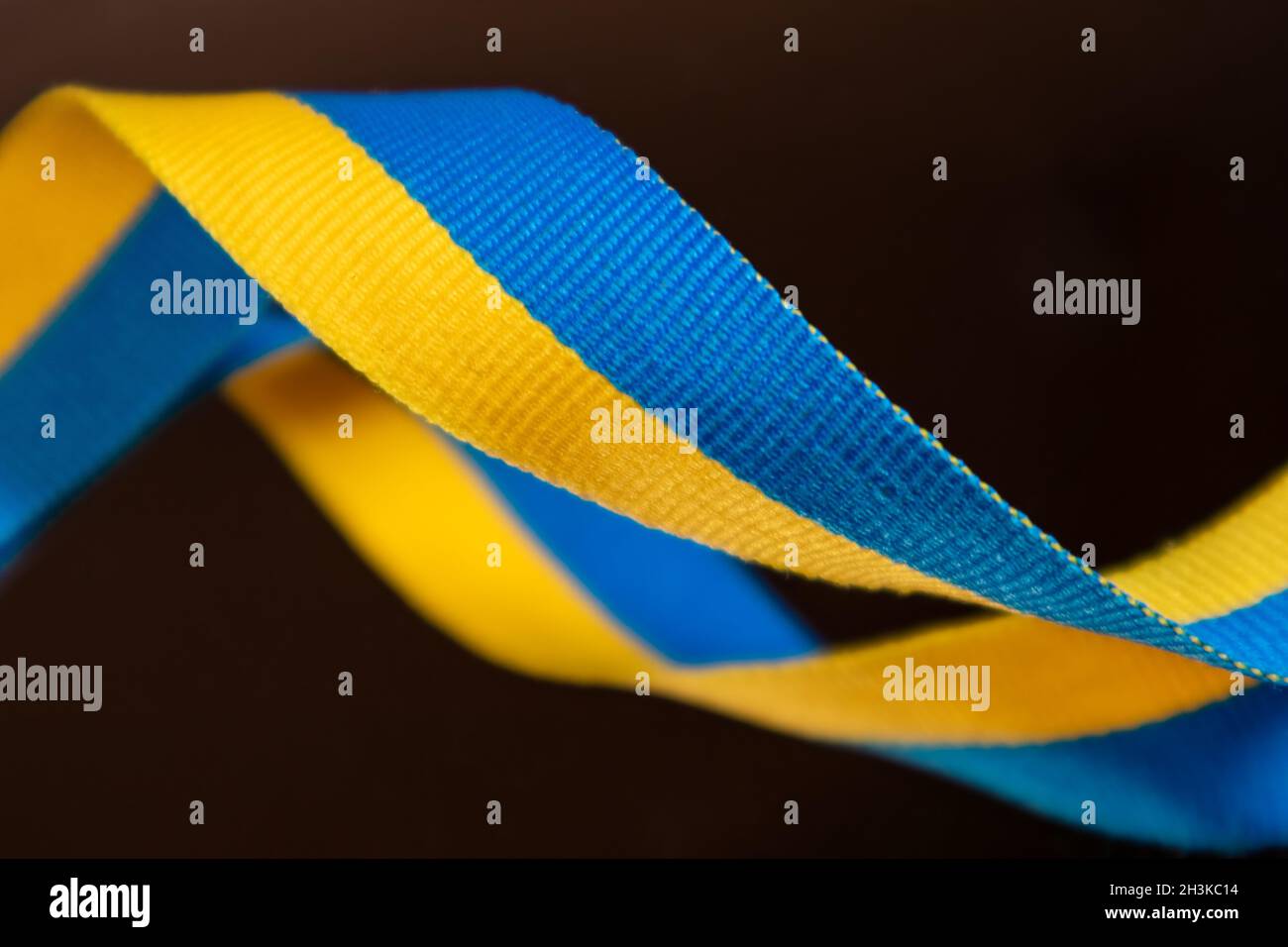 Yellow and blue, Ukrainian national flag colors, fabric ribbon on dark ...