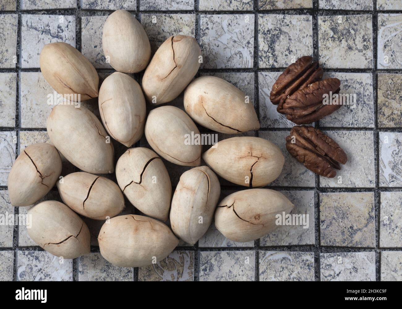 Whole Fried Pecan Nuts with Cracked Shell on Ceramic Table Stock Photo ...