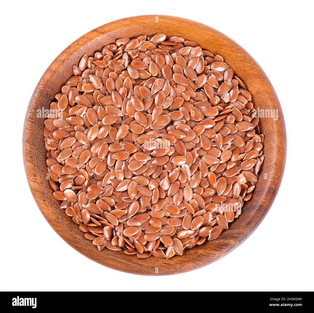 Brown flax seeds in wooden bowl, isolated on white background. Heap of dry flaxseed or linseed ...