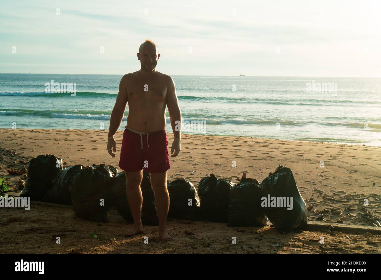 Man cleaning the beach Stock Photo - Alamy