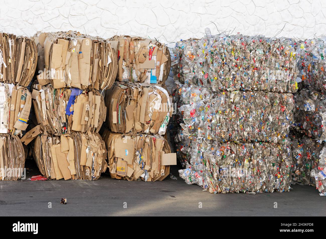 Piles of cardboard boxes and plastic bottles stored for recycling Stock ...