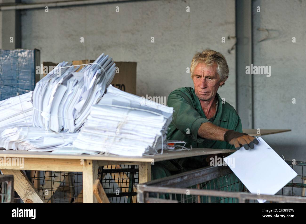 Recycling factory worker at work sorting garbage Stock Photo - Alamy