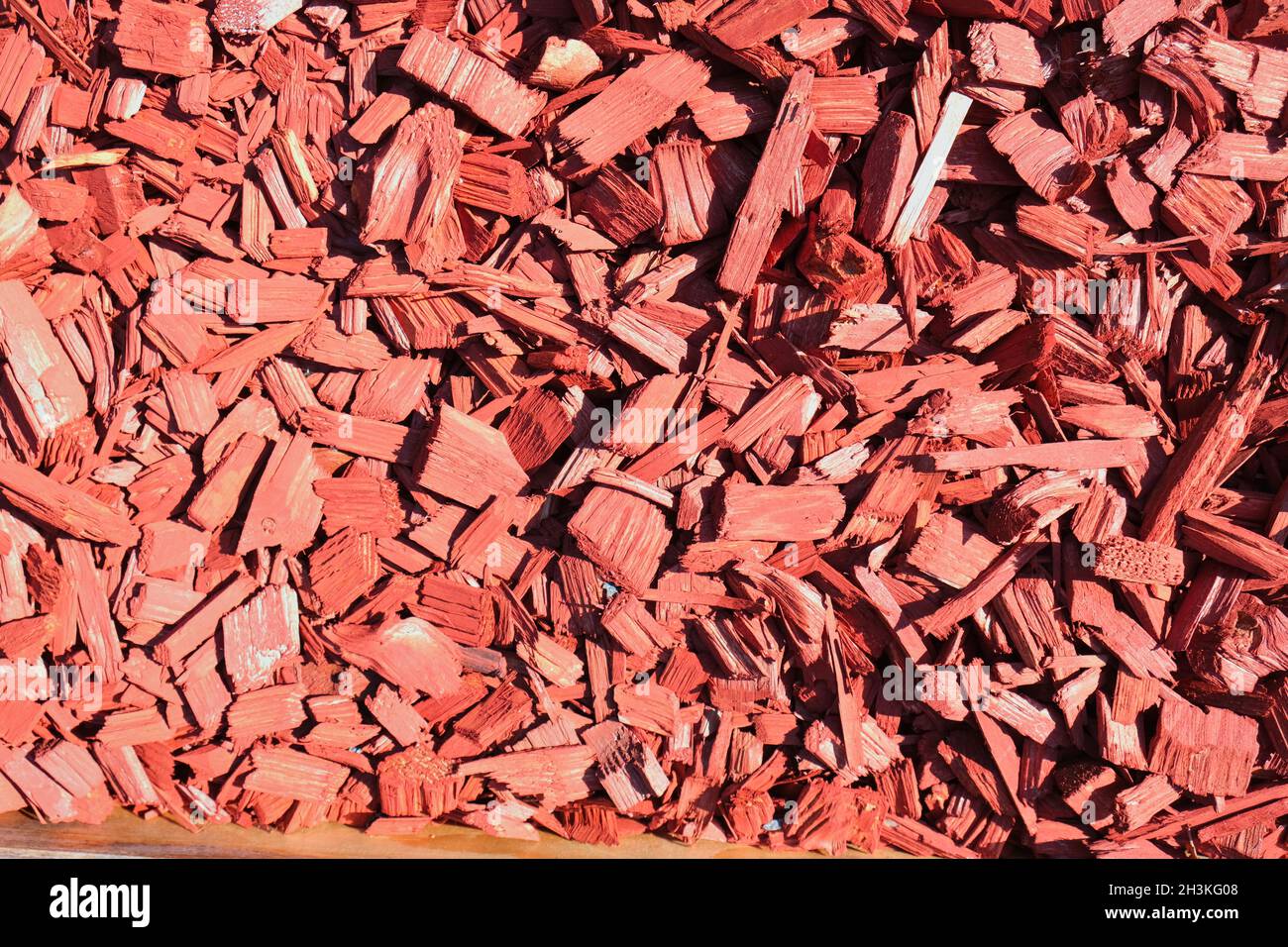 Stack of red tree bark wood chips outdoors under sunlight Stock Photo ...