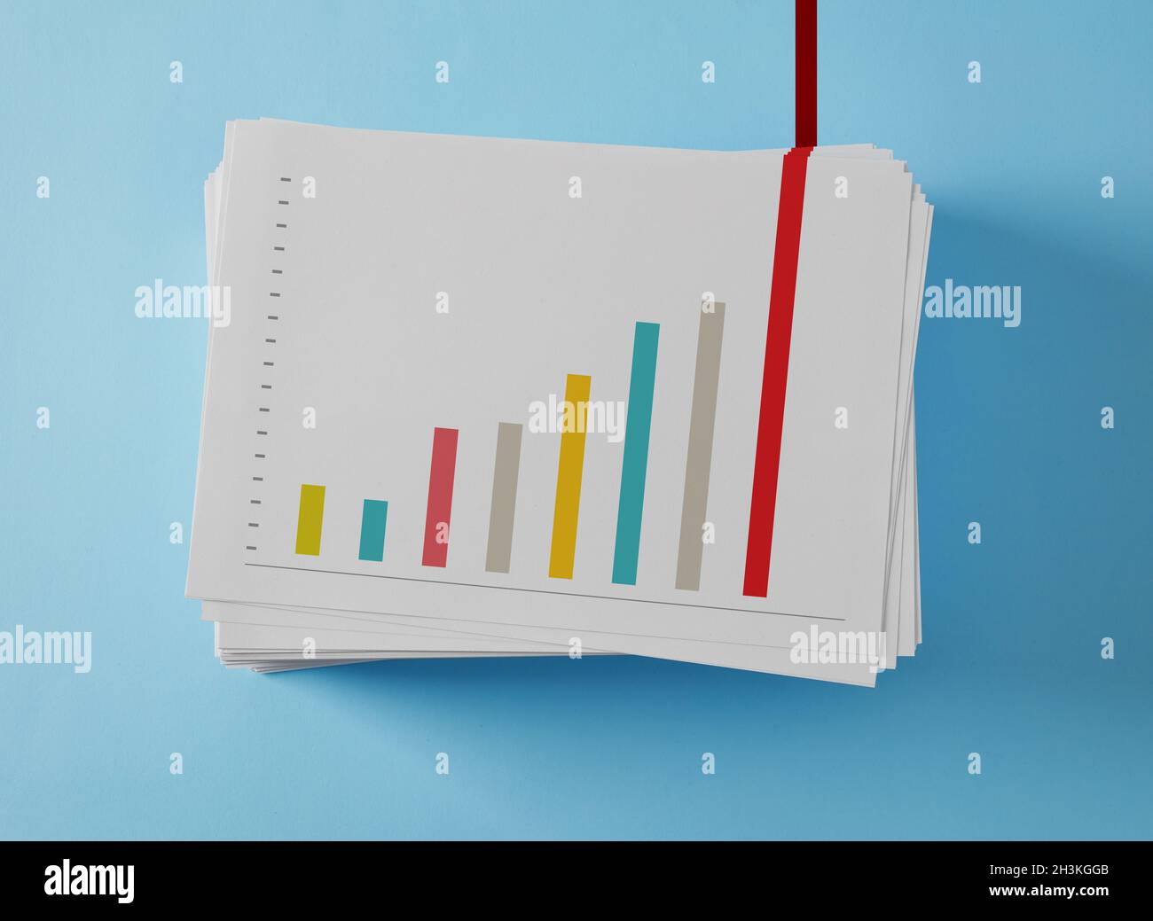 Growing chart on A4 page on blue background Stock Photo - Alamy