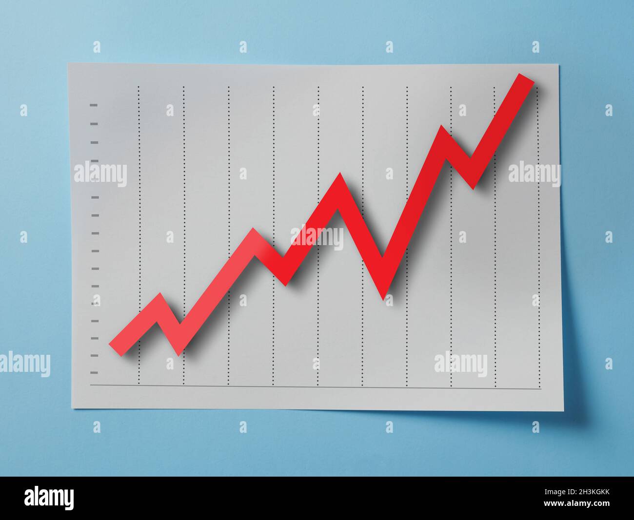 Growing chart on A4 page on blue background Stock Photo - Alamy