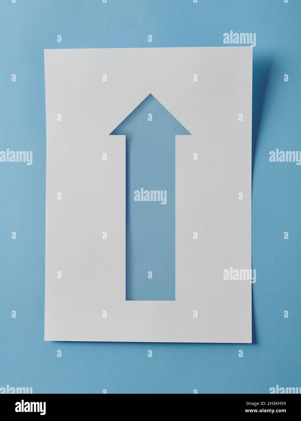 Arrow up on a A4 page from above Stock Photo - Alamy