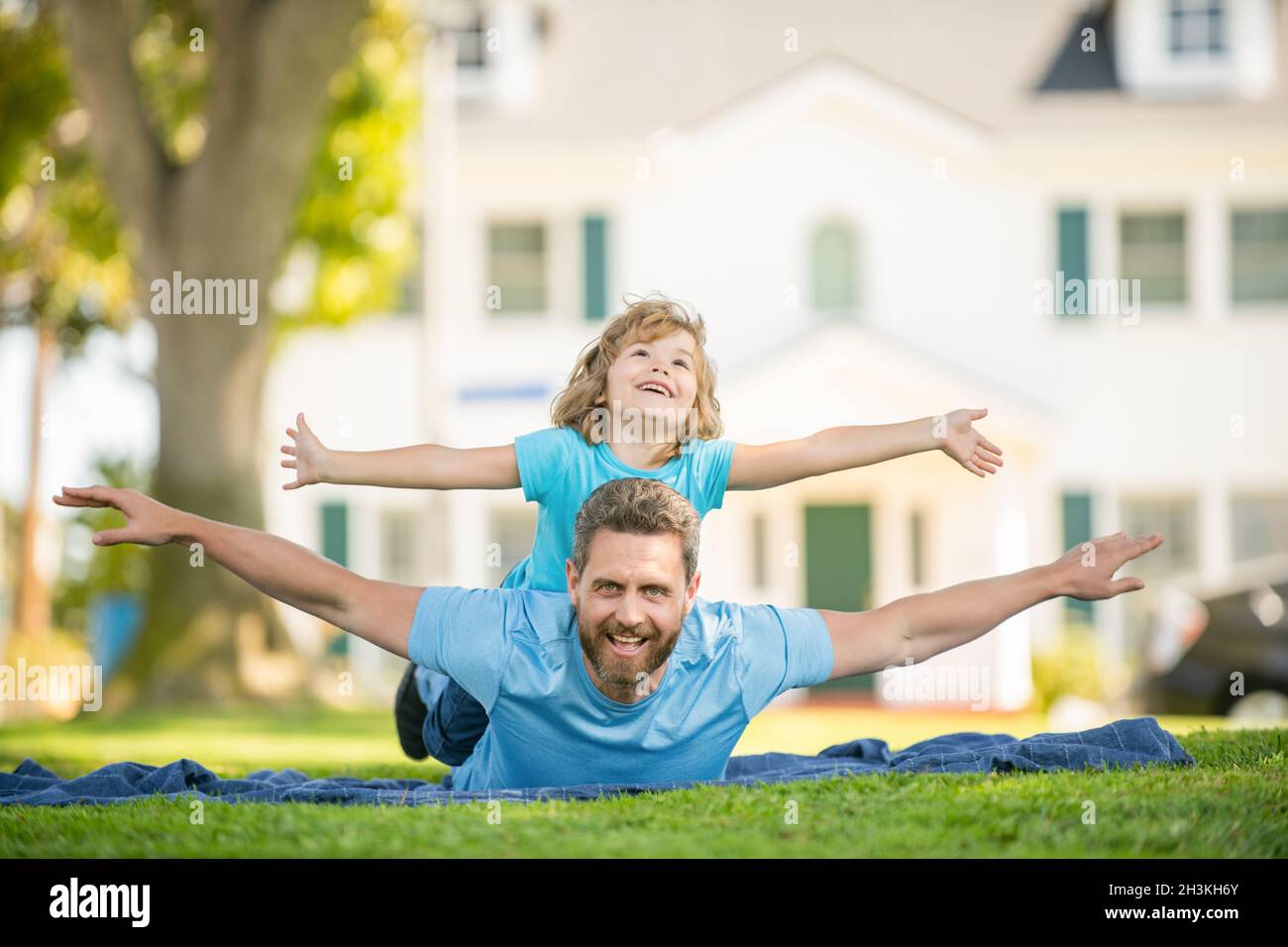 free day of happy father with child relax together on green park grass ...