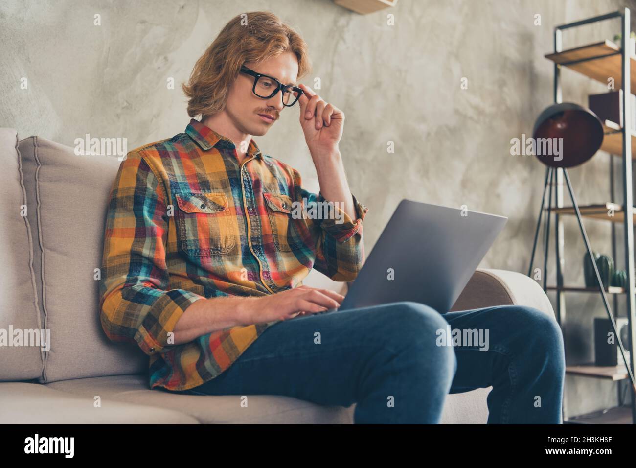 Profile side photo of young guy hand touch glasses focused browse ...
