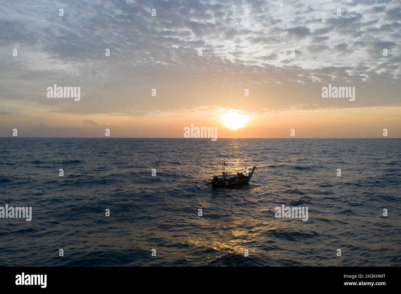 Aerial view of sea with boat over beautiful sunset Stock Photo - Alamy