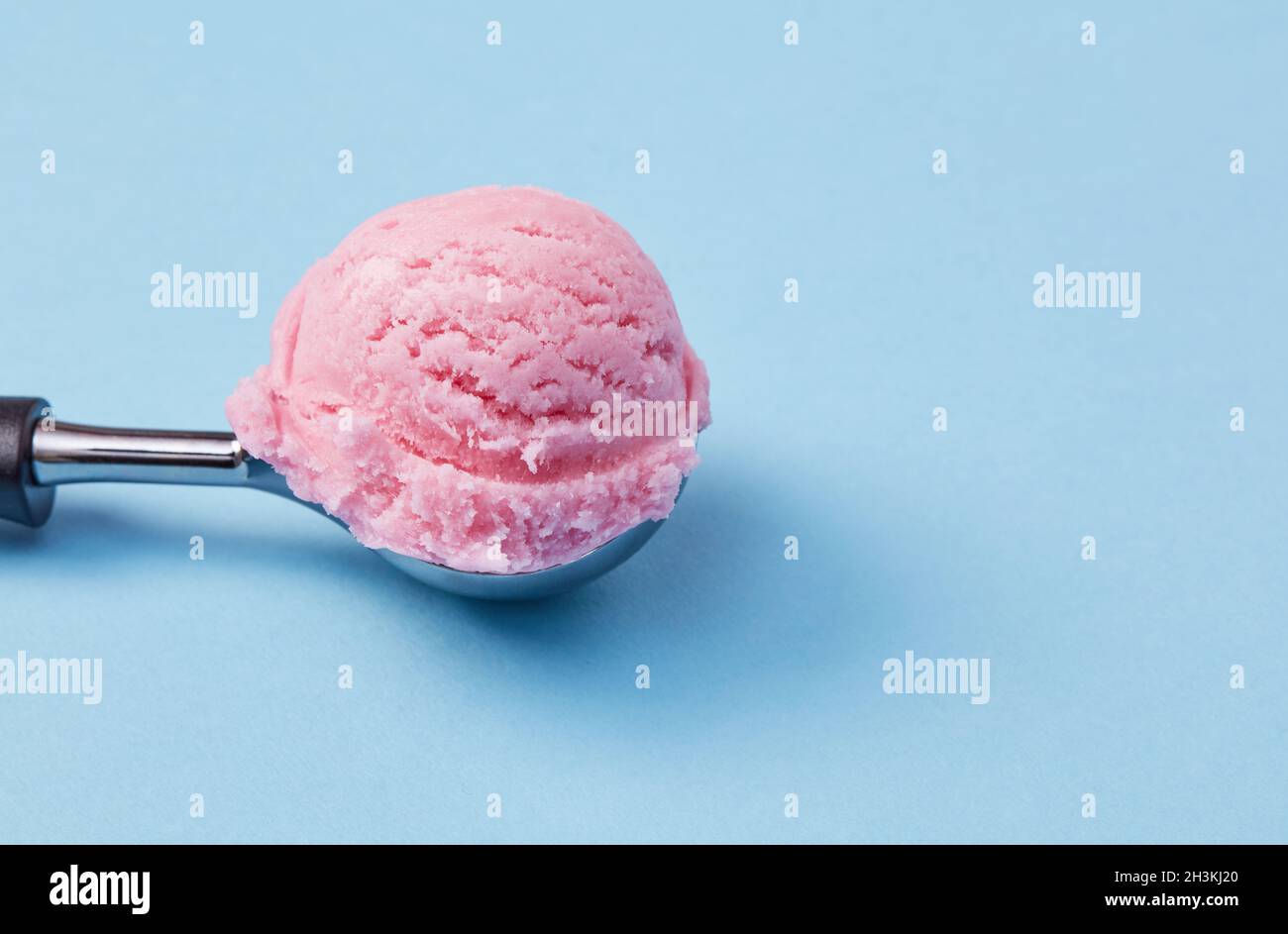Ice cream scoop on blue background Stock Photo - Alamy
