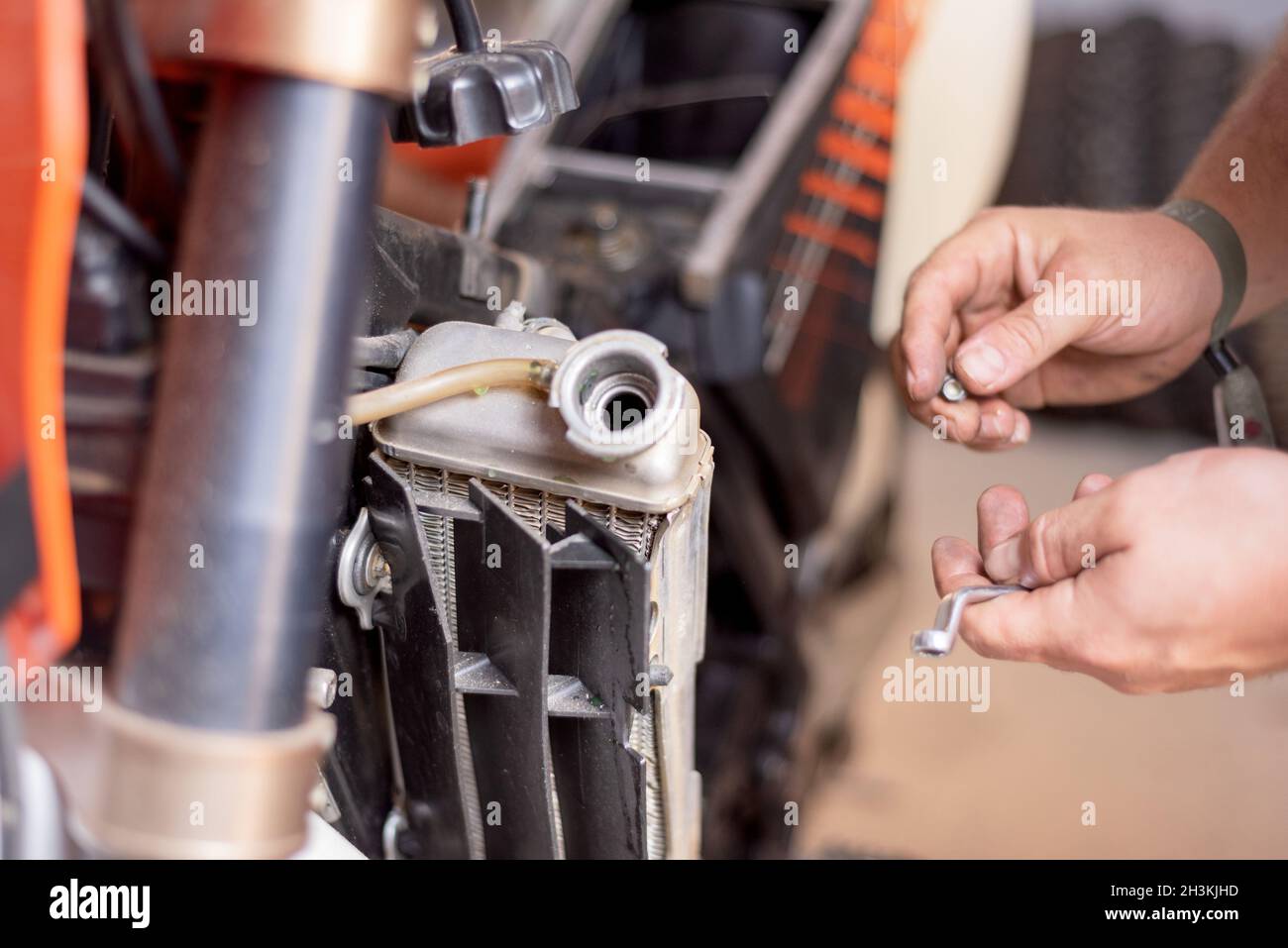 Motorbike mechanic, replacing the cooling radiator. Replacement or ...