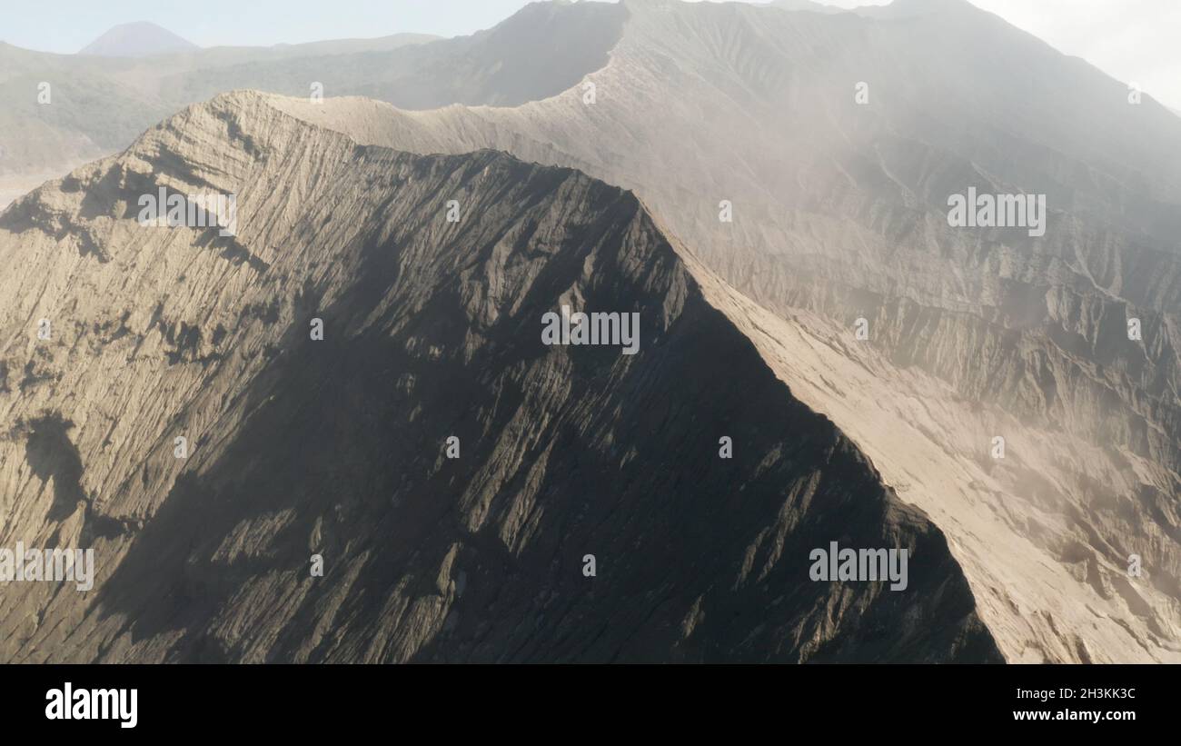 Cinematic aerial view of Mount Bromo crater edge with active volcano ...