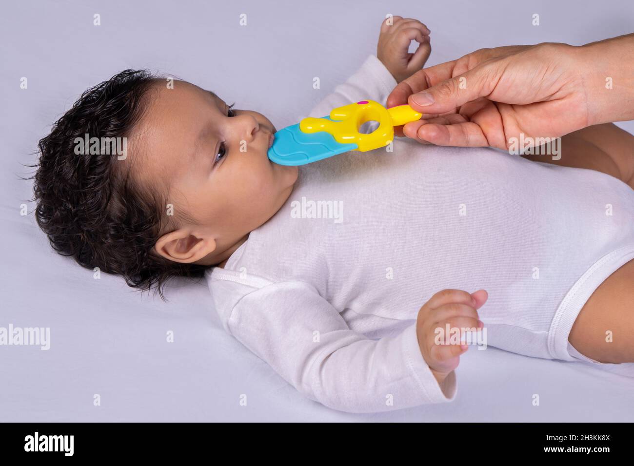 Infant hand toy hi-res stock photography and images - Alamy