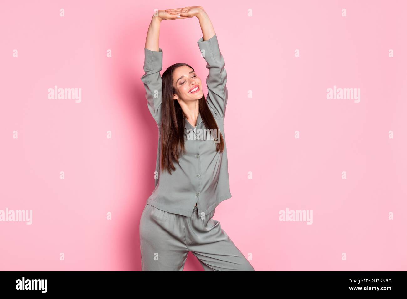 Photo of sweet cute woman nightwear smiling rising arms closed eyes ...