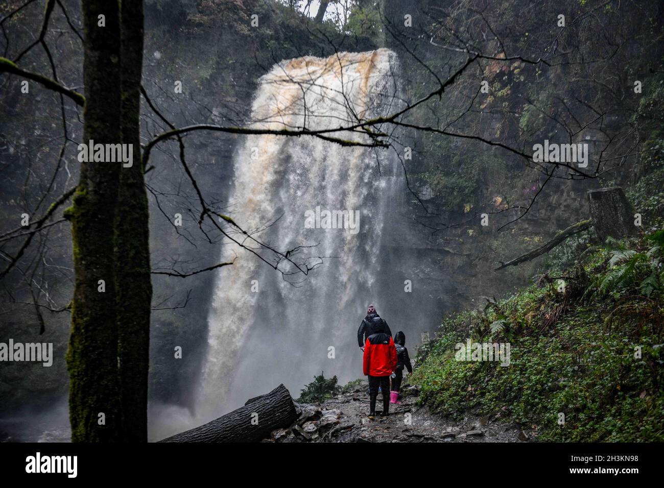 A family stand head towards Henryd Falls in the Brecon Beacons, Wales ...