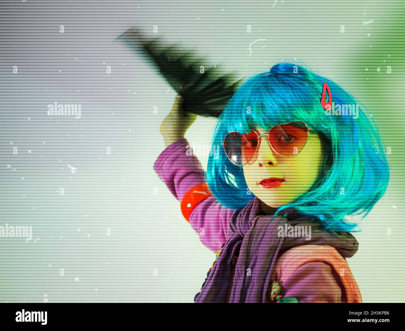 Little girl posing with a fan for a photo shoot on a colorful ...