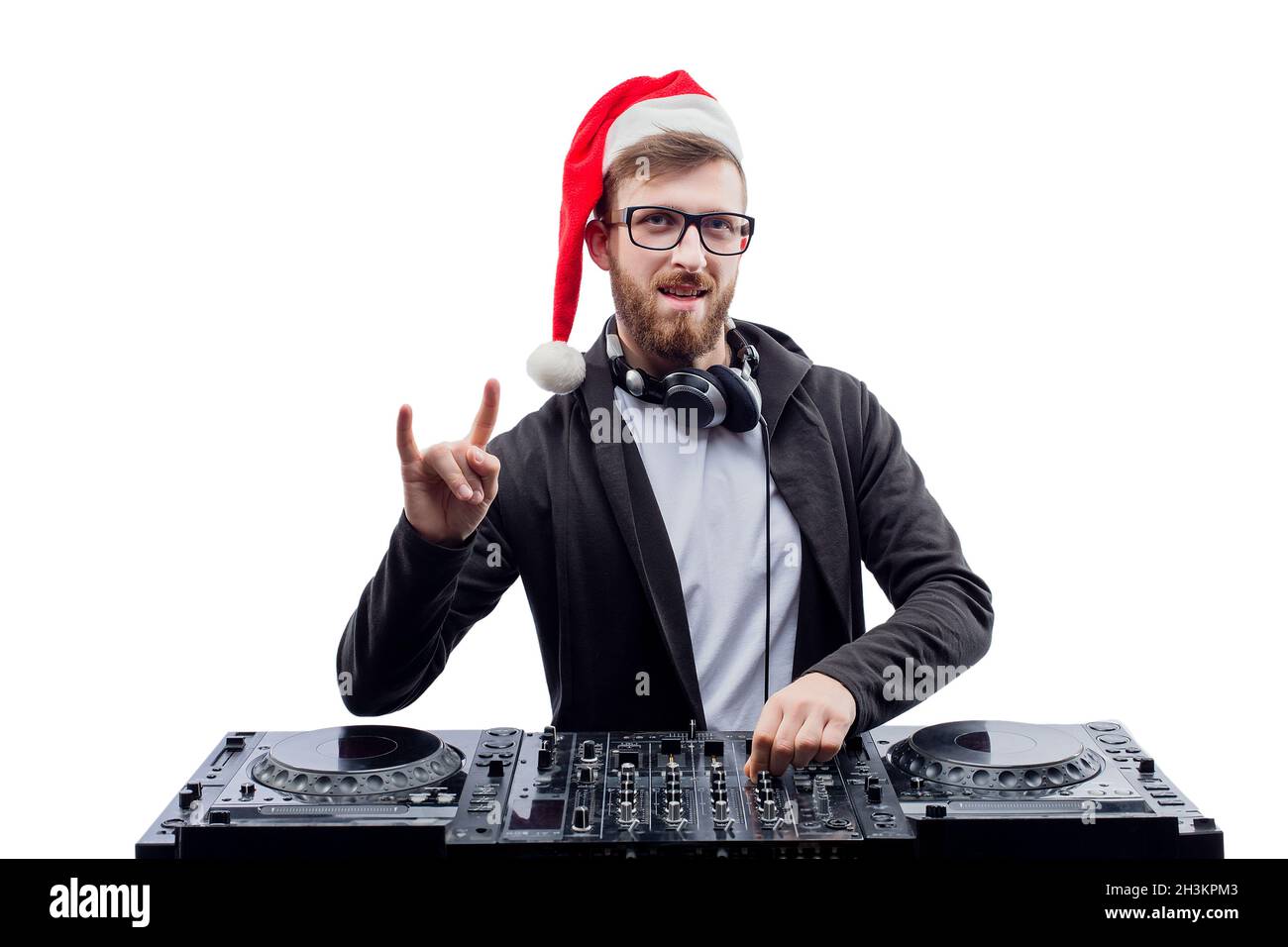 Funny dj guy in Santa's hat, glasses plays music on a turntable while ...