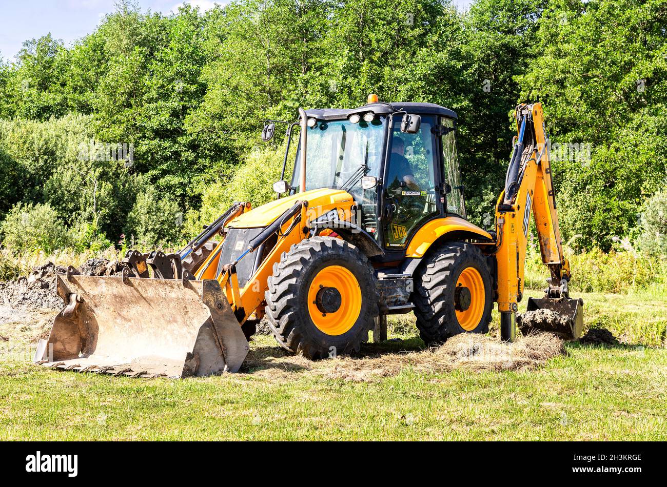 Moscow, Russia - July 30, 2021: JCB wheeled tractor excavating at the ...