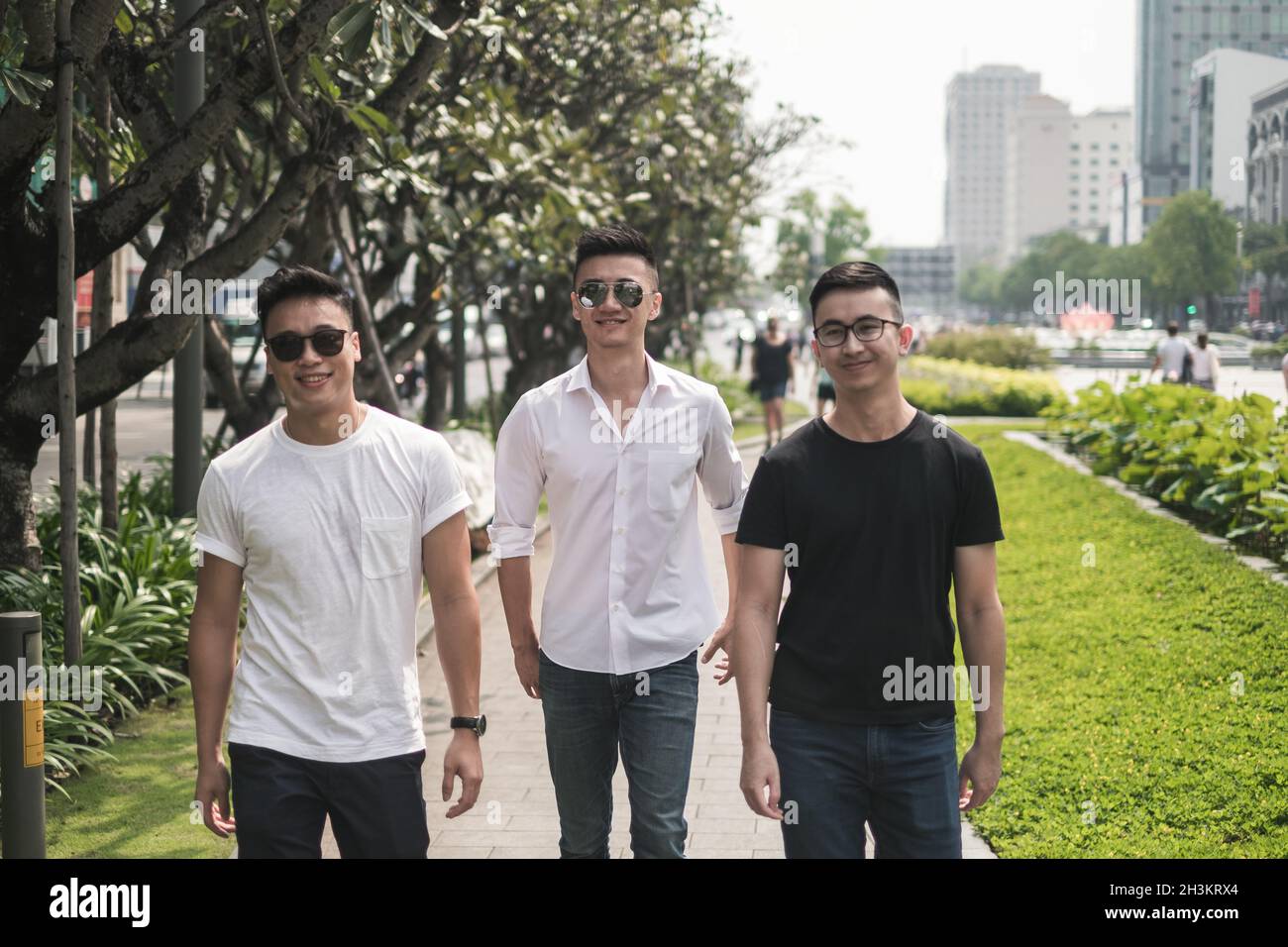 Portrait of Three asian young men in casual clothing walking on the ...